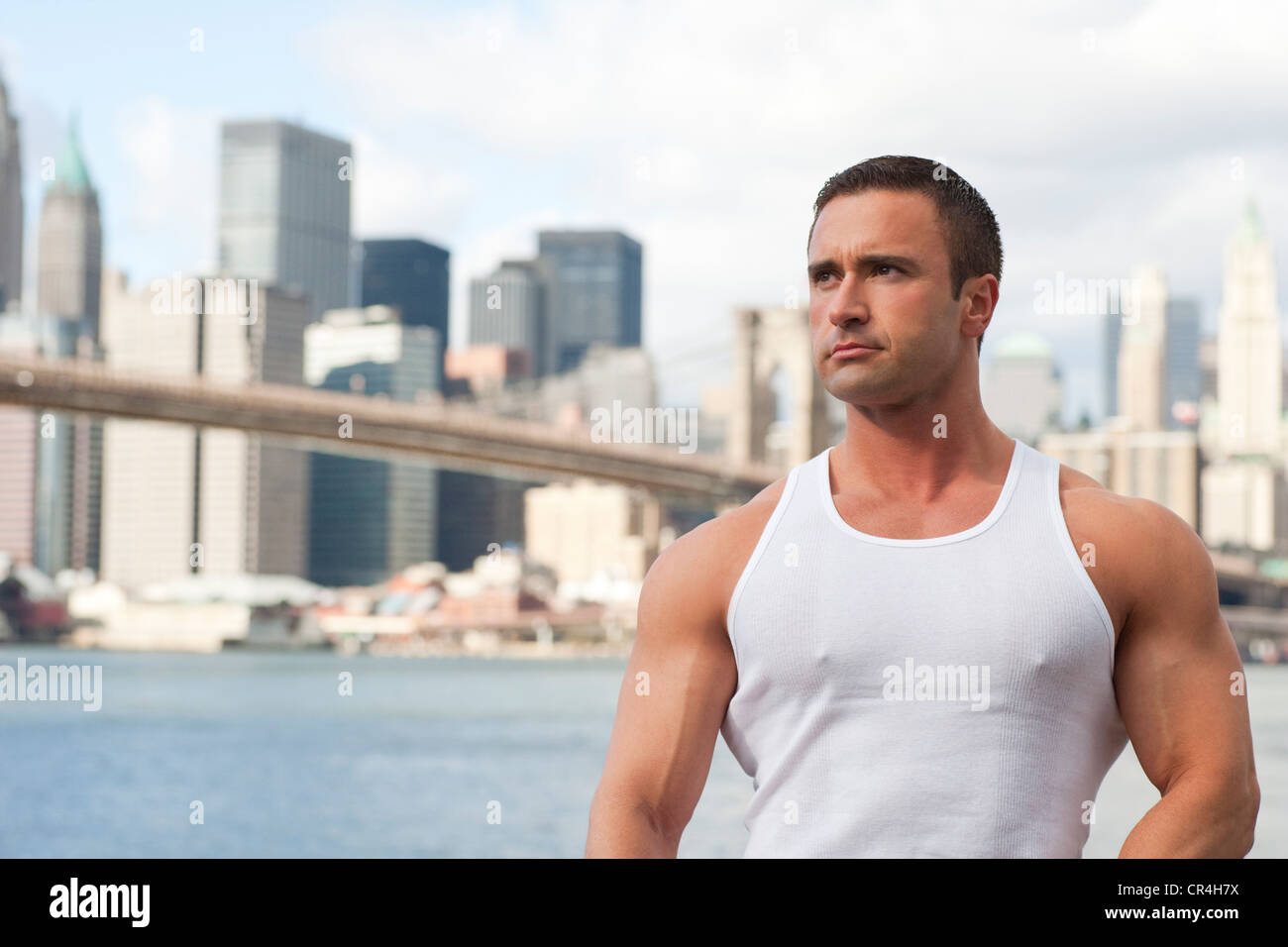 Portrait of fit and healthy looking Caucasian man wearing white singlet ...