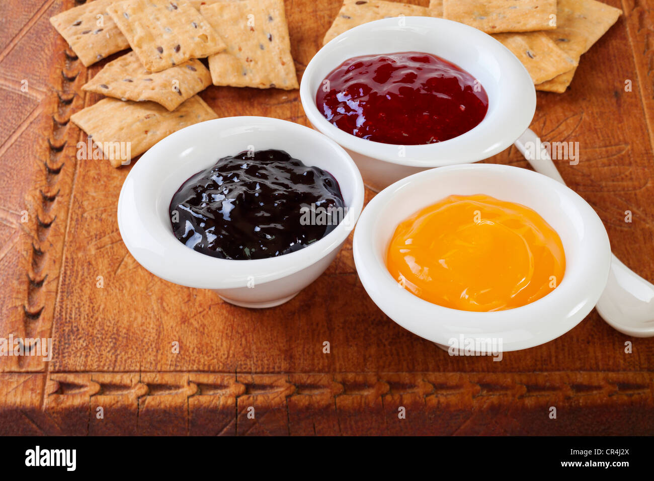 Selection of jams with crisp biscuits for tasting on an old wooden ...