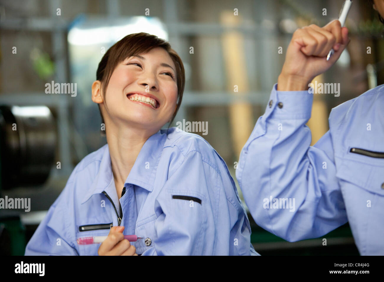 Two Young Factory Workers Stock Photo - Alamy