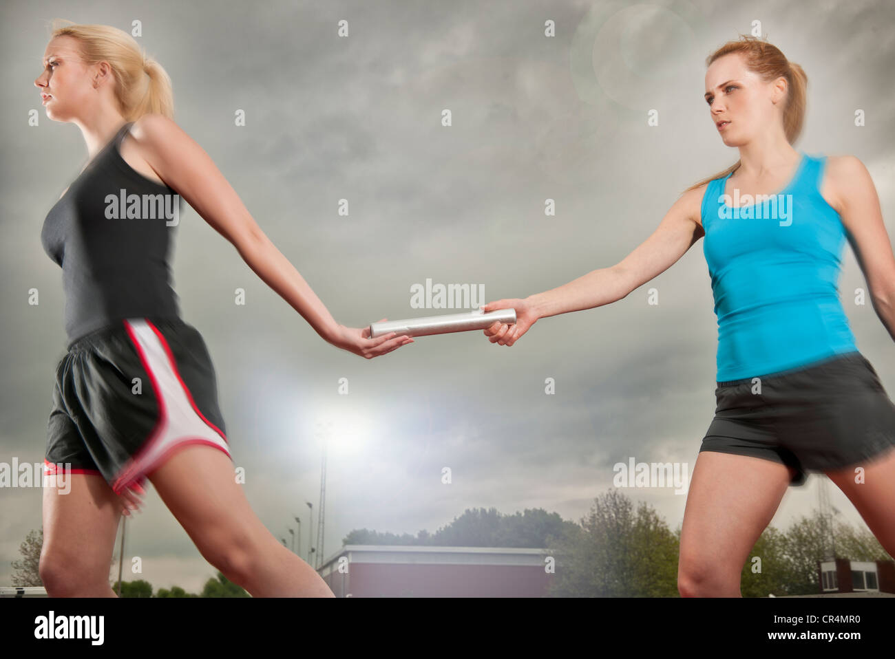 women passing relay baton Stock Photo - Alamy