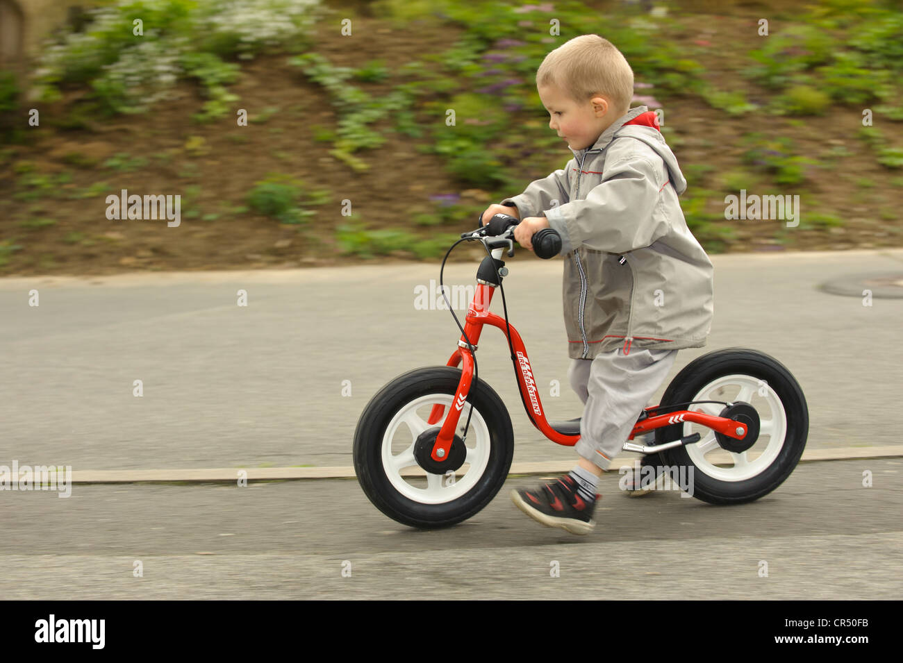Child rides balance bike on hi-res stock photography and images - Alamy