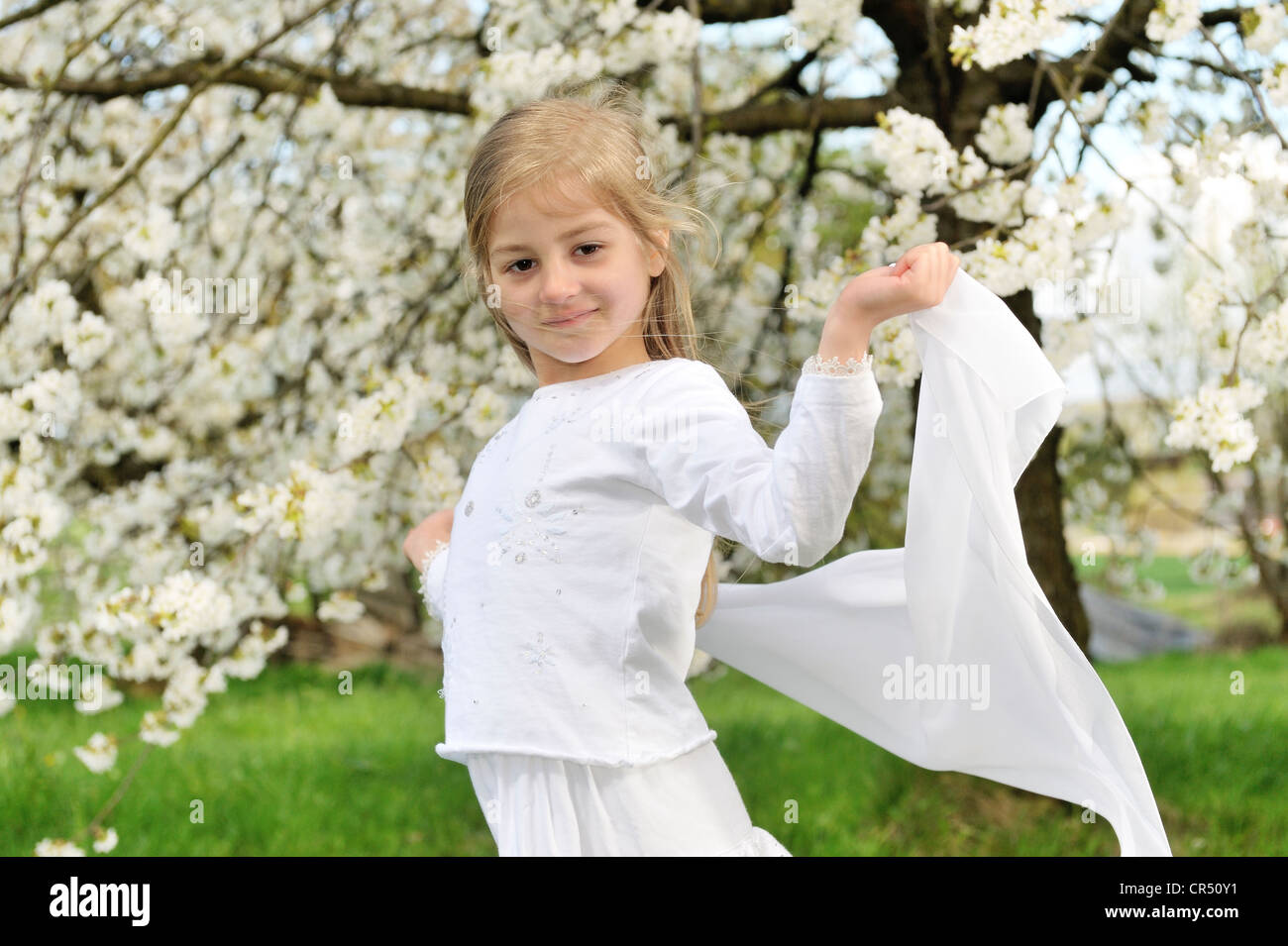 Girl, 6 years, in spring in front of a flowering tree Stock Photo - Alamy