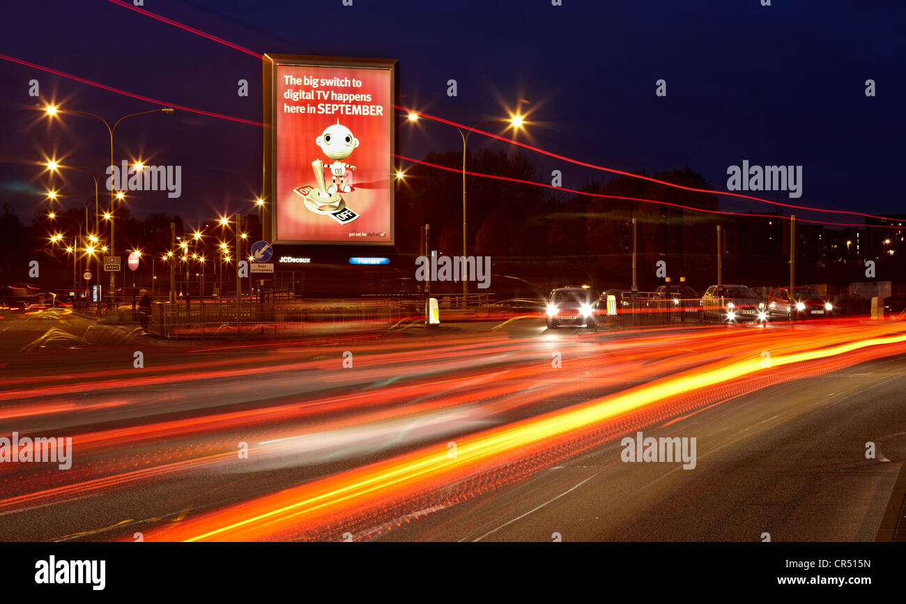 Outdoor roadside advertising panel showing a digital switchover ...