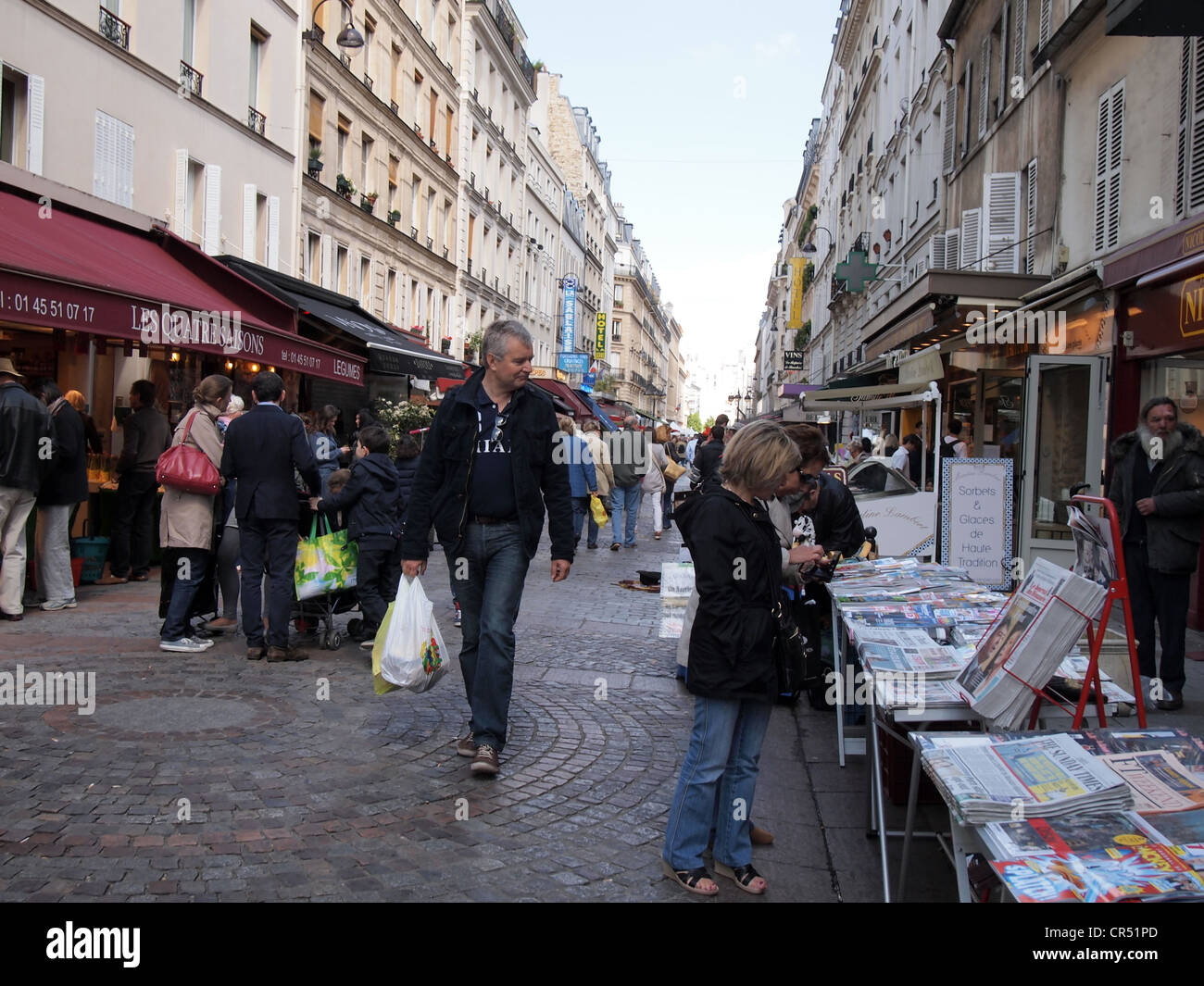 People shopping along Rue Cler in Paris, France, May 13, 2012 ...