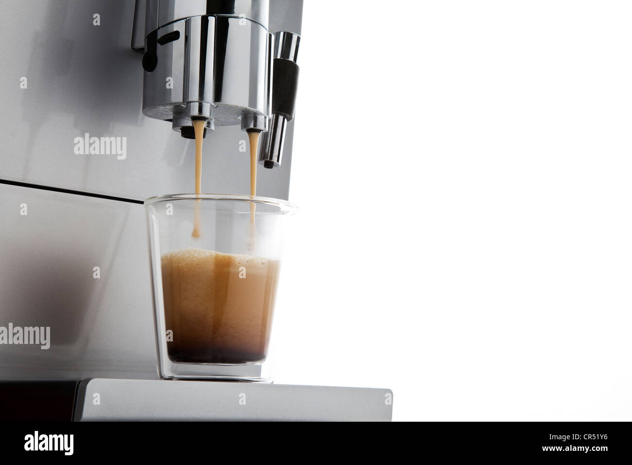 Coffee flowing from espresso machine into glass cup Stock Photo - Alamy