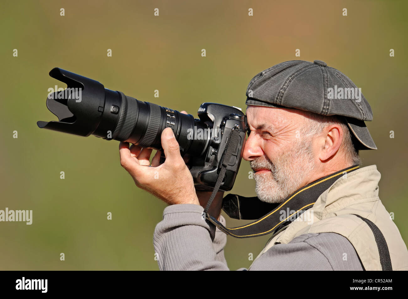 Man holding a camera, photographer taking a photograph Stock Photo - Alamy