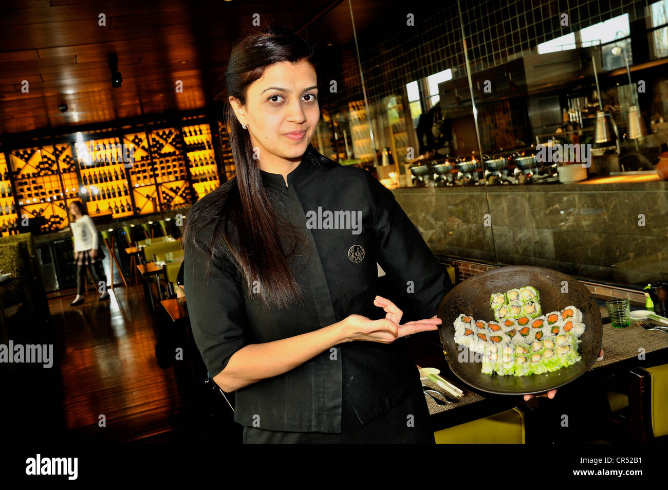 Waitress holding sushi in the restaurant Chinar, Baku, Azerbaijan ...