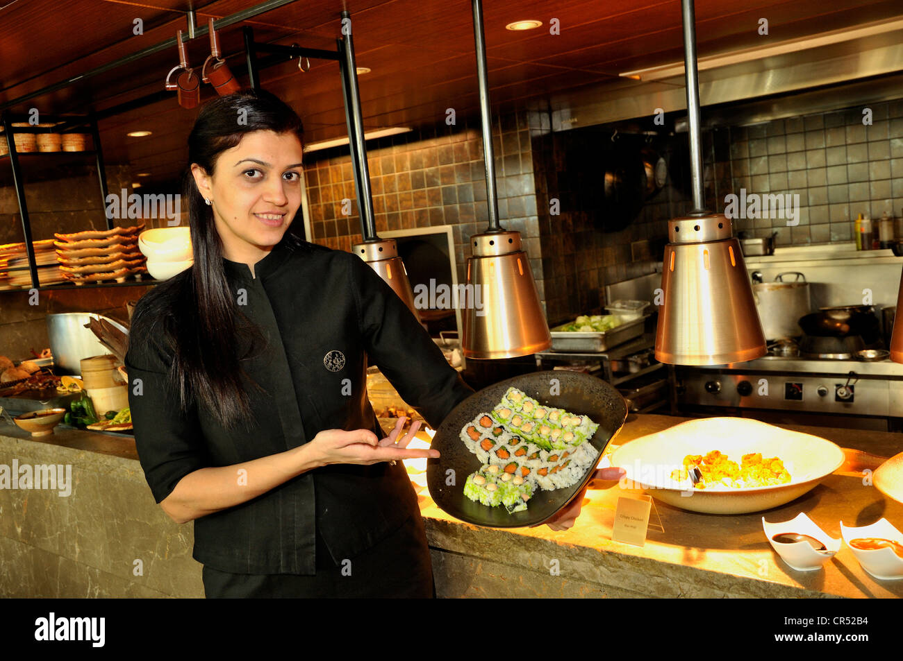 Waitress holding sushi in the restaurant Chinar, Baku, Azerbaijan ...