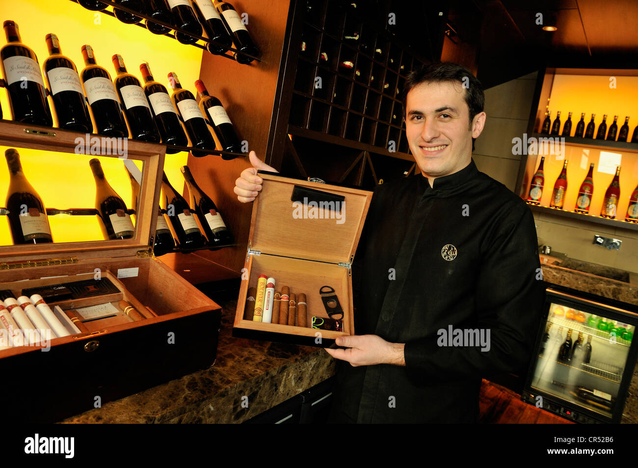 Waiter holding a box of cigars in the restaurant Chinar, Baku ...