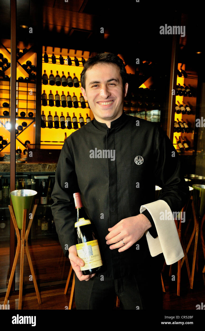 Waiter with a bottle of wine in the restaurant Chinar, Baku, Azerbaijan ...