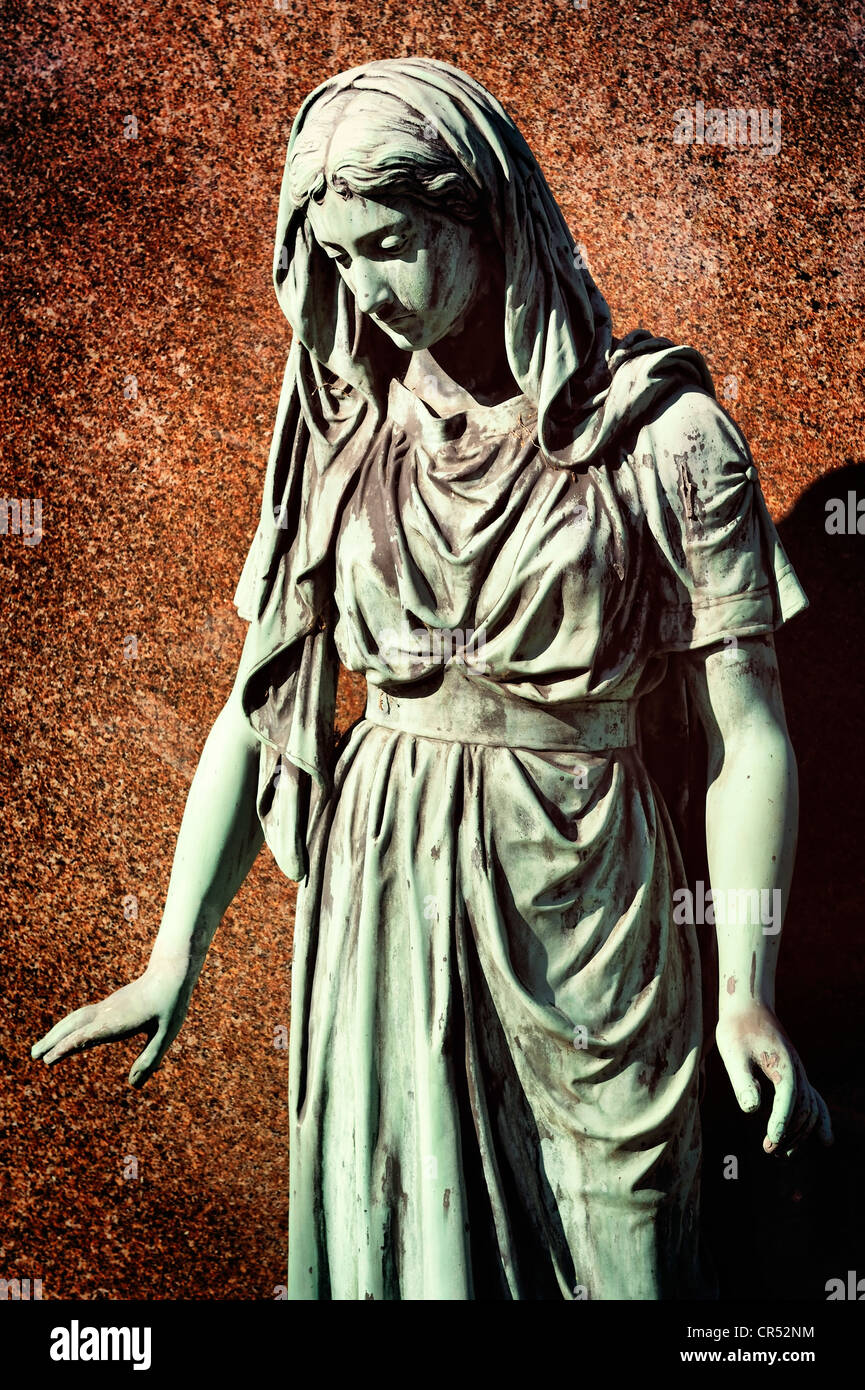 Statue of a grieving woman at Ohlsdorf Cemetery in Hamburg, Germany ...