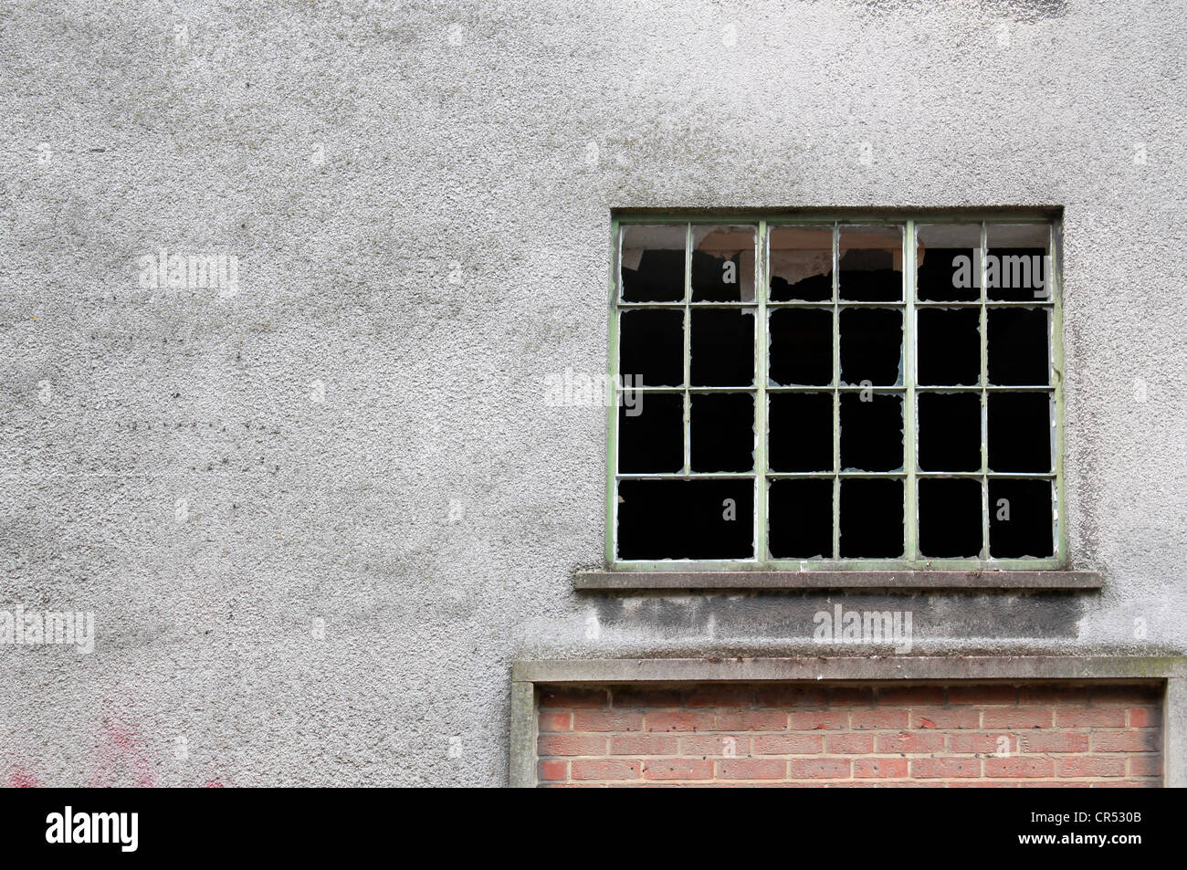 Broken window in derelict factory with blank space Stock Photo - Alamy