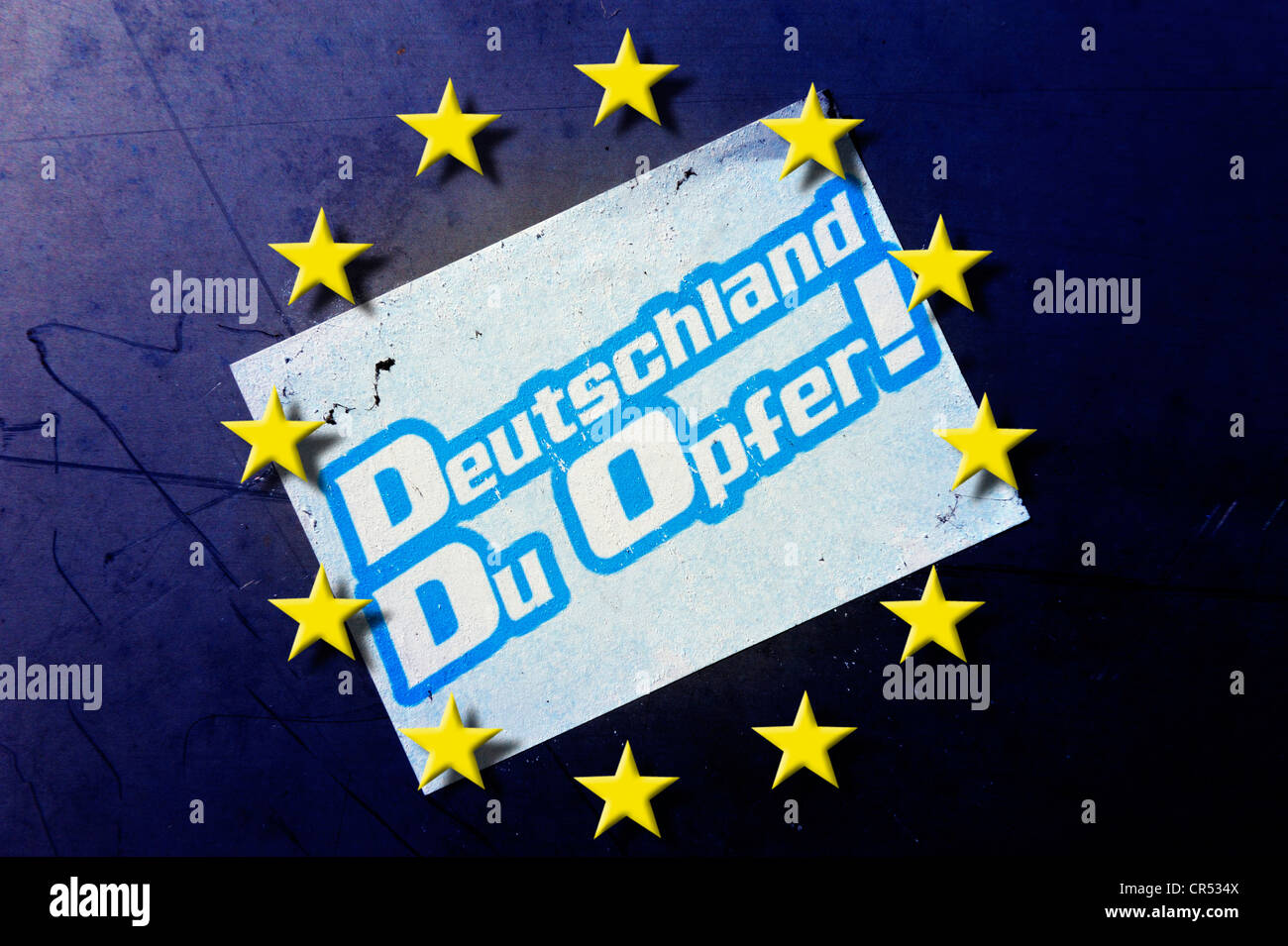 EU stars and sticker on a wall, "Deutschland, Du Opfer!", German for ...