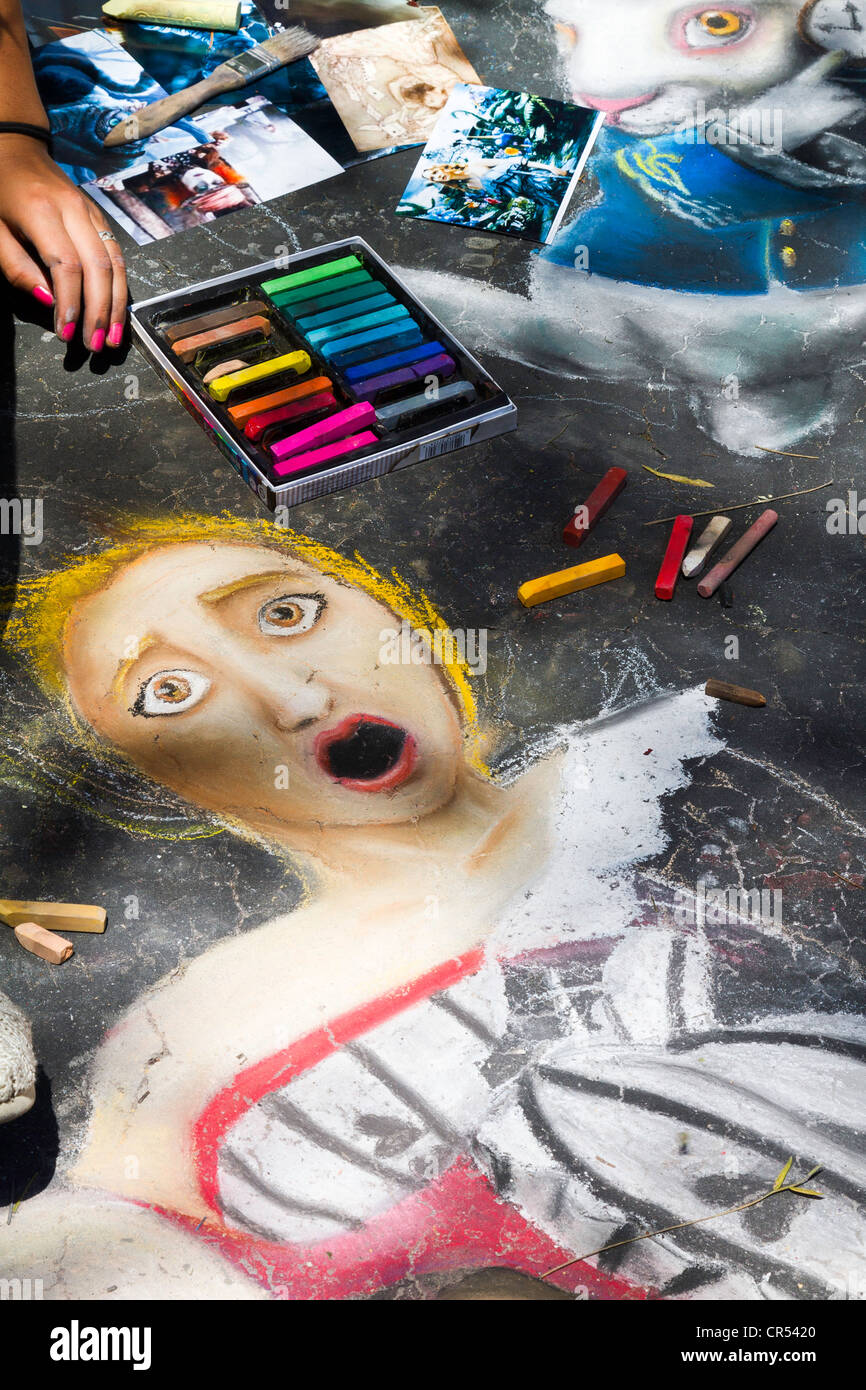 Artist doing chalk drawing on pavement in "Santa Barbara" California ...