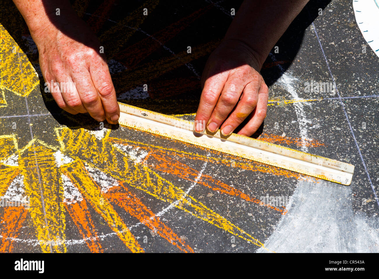 Artist doing chalk drawing on pavement in "Santa Barbara" California ...