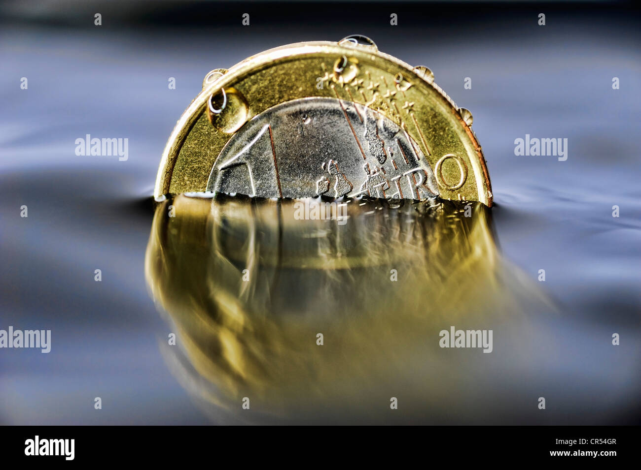 A euro coin sinking in water, symbolic image for the debt crisis in ...