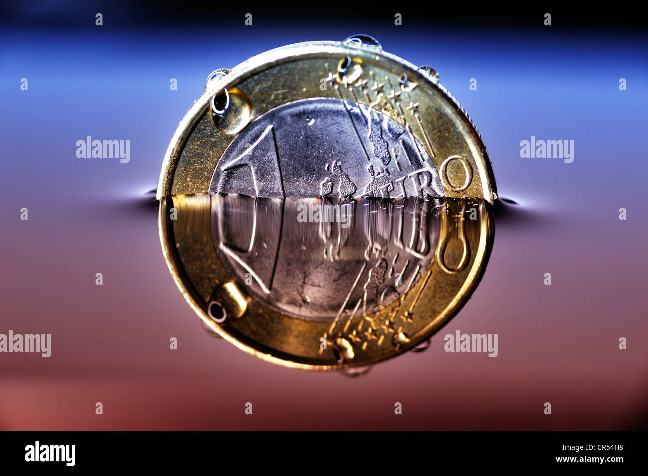 A euro coin sinking in water, symbolic image for the debt crisis in ...