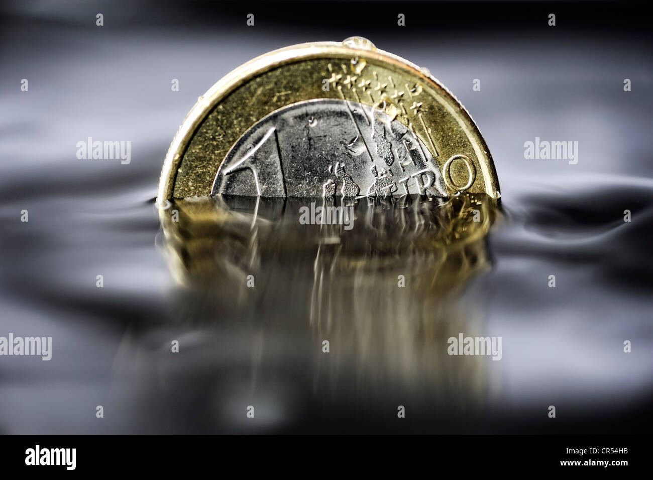 A euro coin sinking in water, symbolic image for the debt crisis in ...