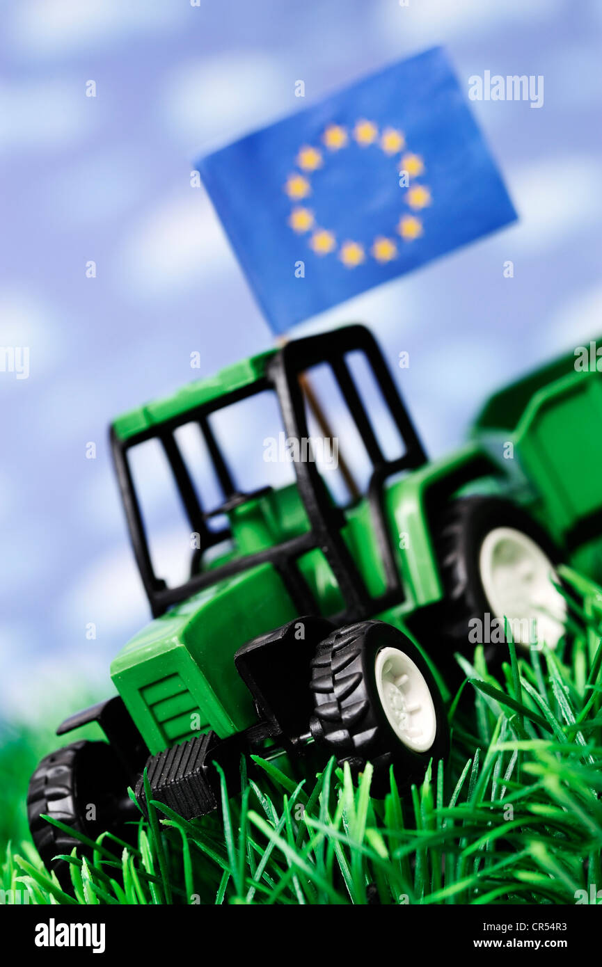 Miniature tractor with a flag of Europe, symbolic image for financial ...