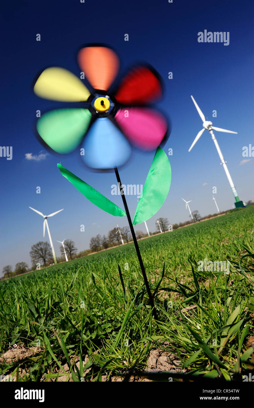 Colorful pinwheel in front of wind turbines, symbolic image for wind ...