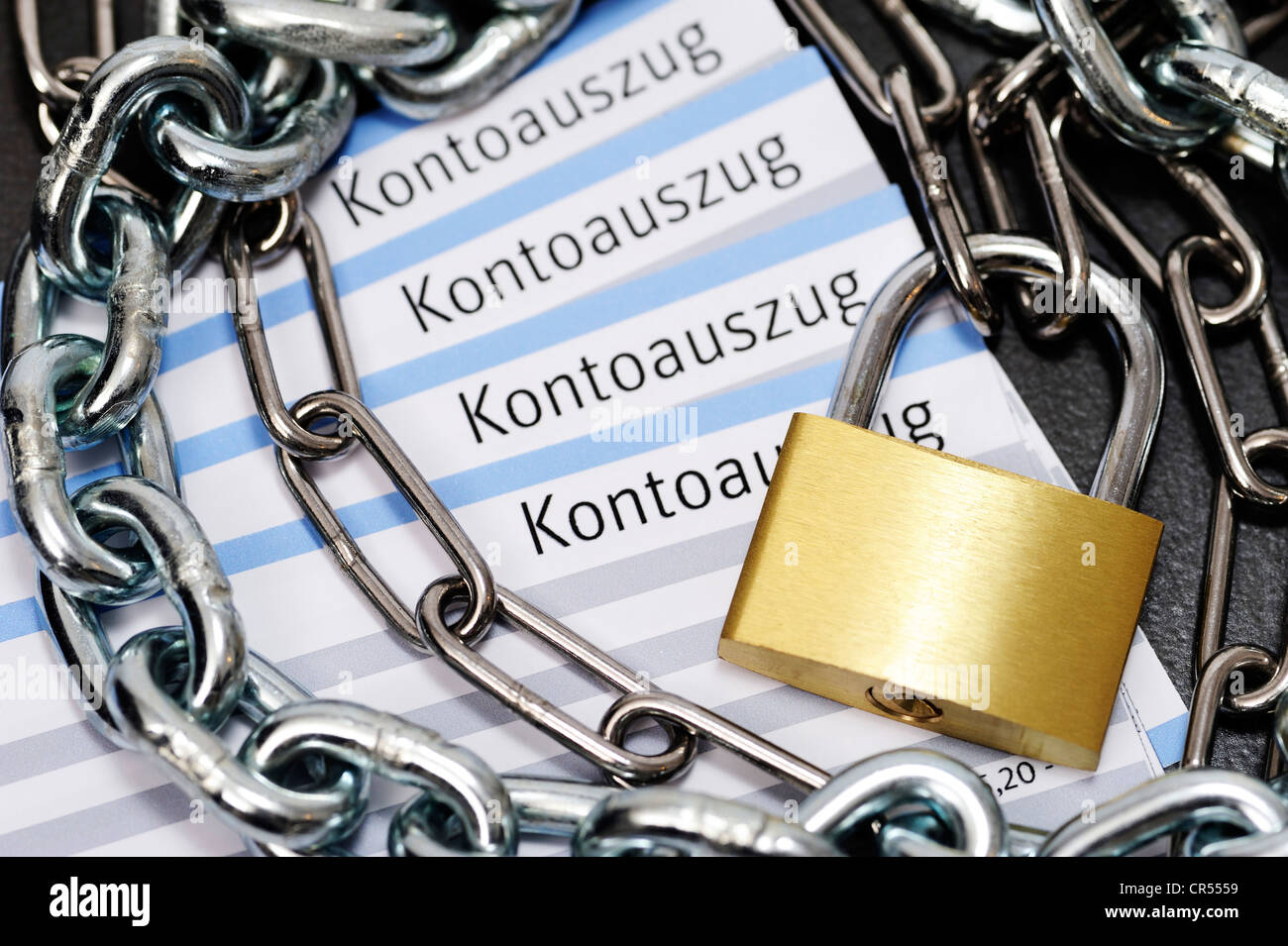 Bank statements with chains and a padlock, symbolic image Stock Photo ...