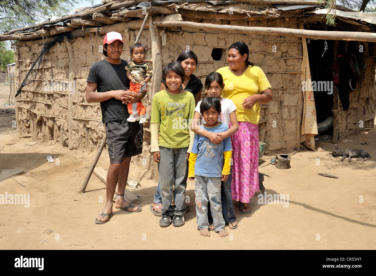Family from the Wichi Indians tribe in front of their mud-brick hut ...