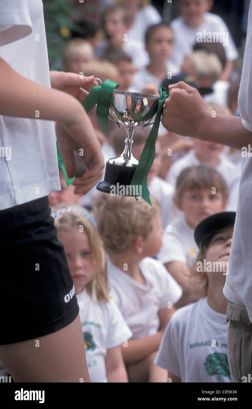 schoolchildren at sports day holding trophy Stock Photo - Alamy