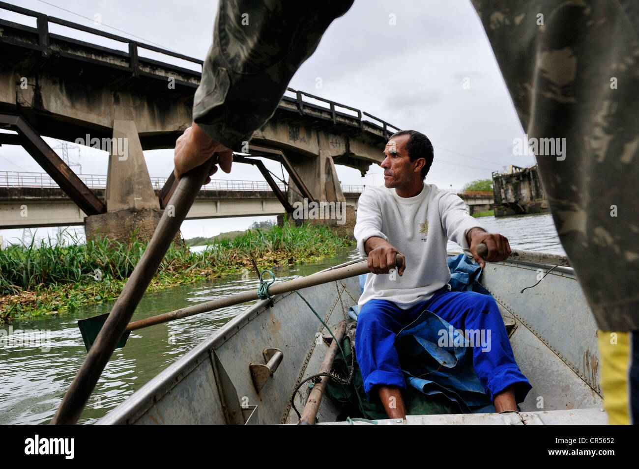 Fishermen rowing a boat under a bridge in the Rio Sao Francisco, since ...