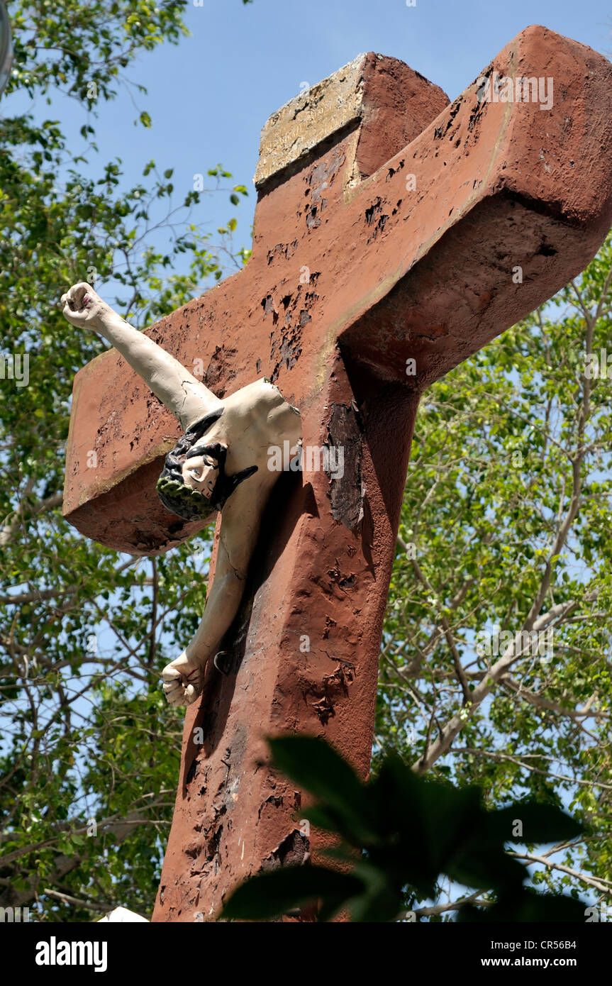 Destroyed Jesus figure hanging from a crucifix, destroyed by the ...