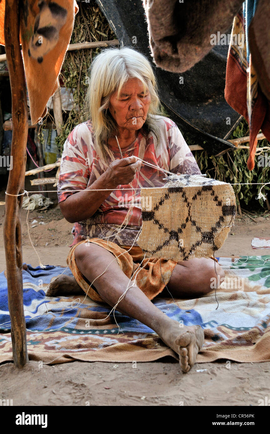 Traditional arts and crafts, old woman creating a Yica bag from fibers ...