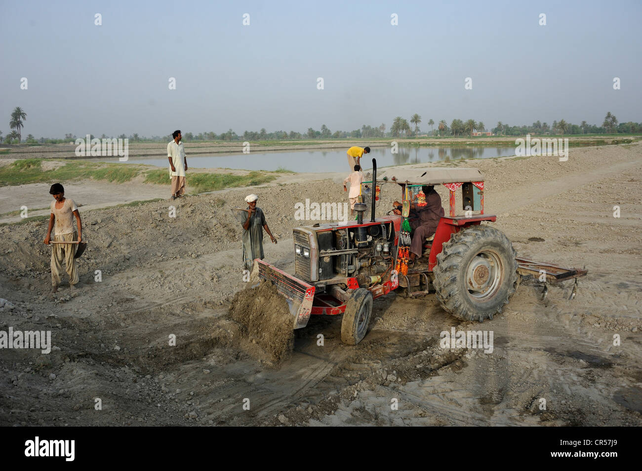Tractor digging a fish pond, Basti Lehar Walla village, Punjab ...