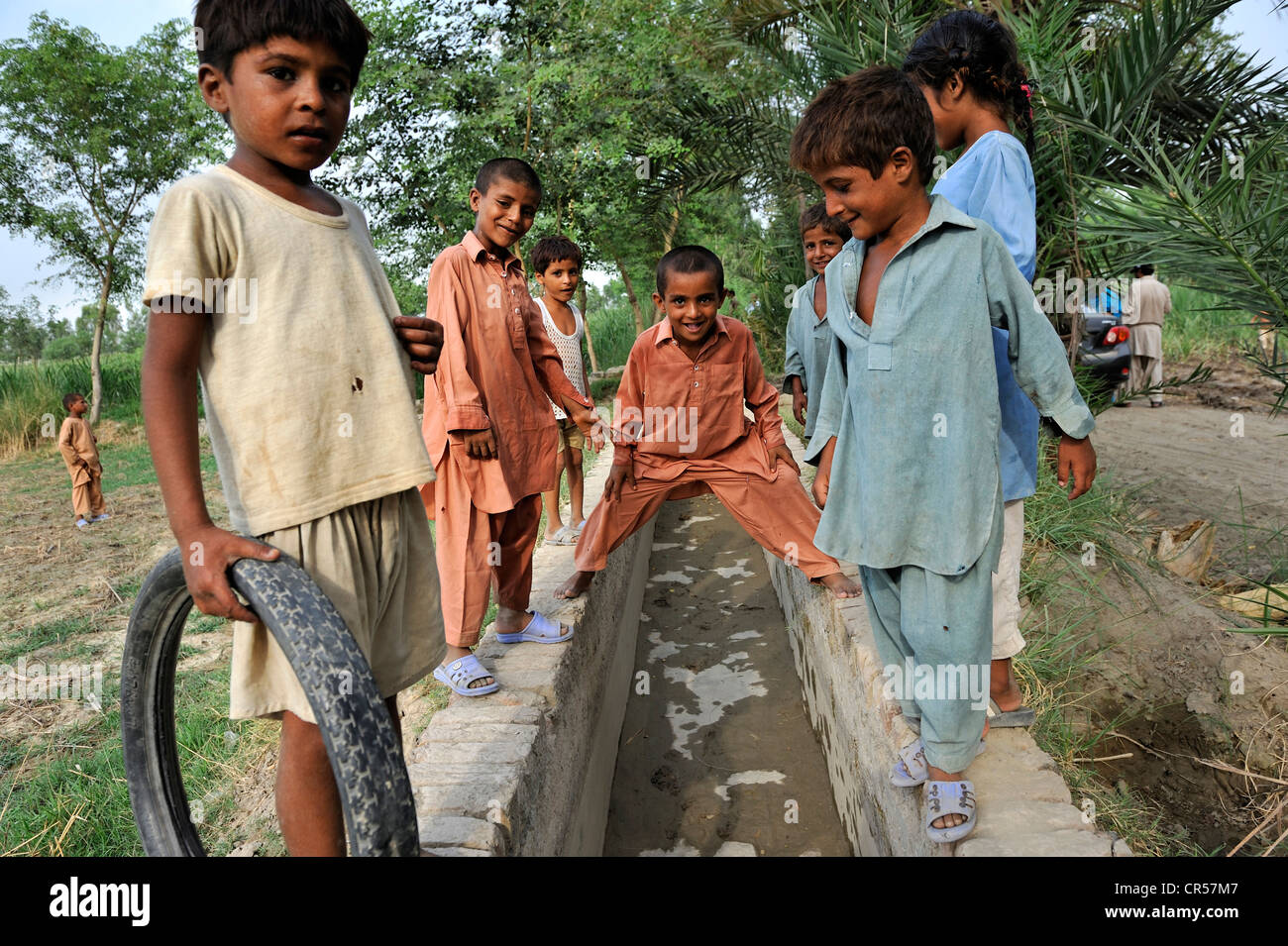 Children playing at an irrigation canal, Basti Lehar Walla village ...