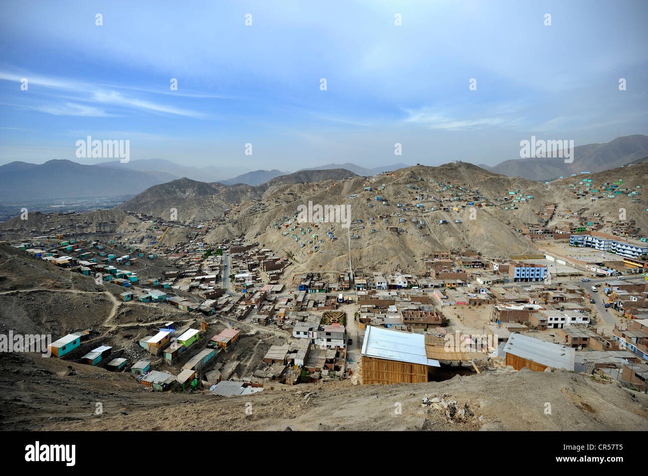 Houses built on sandy slopes in the dry desert climate, slums of Amauta ...