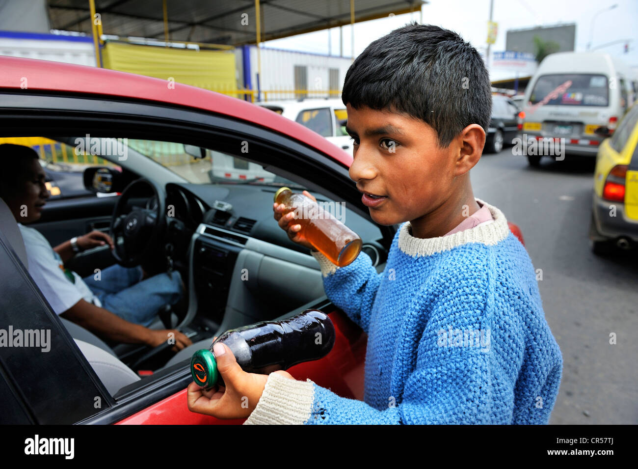 Child labour, boy, 11 years, selling soft drinks at an intersection ...