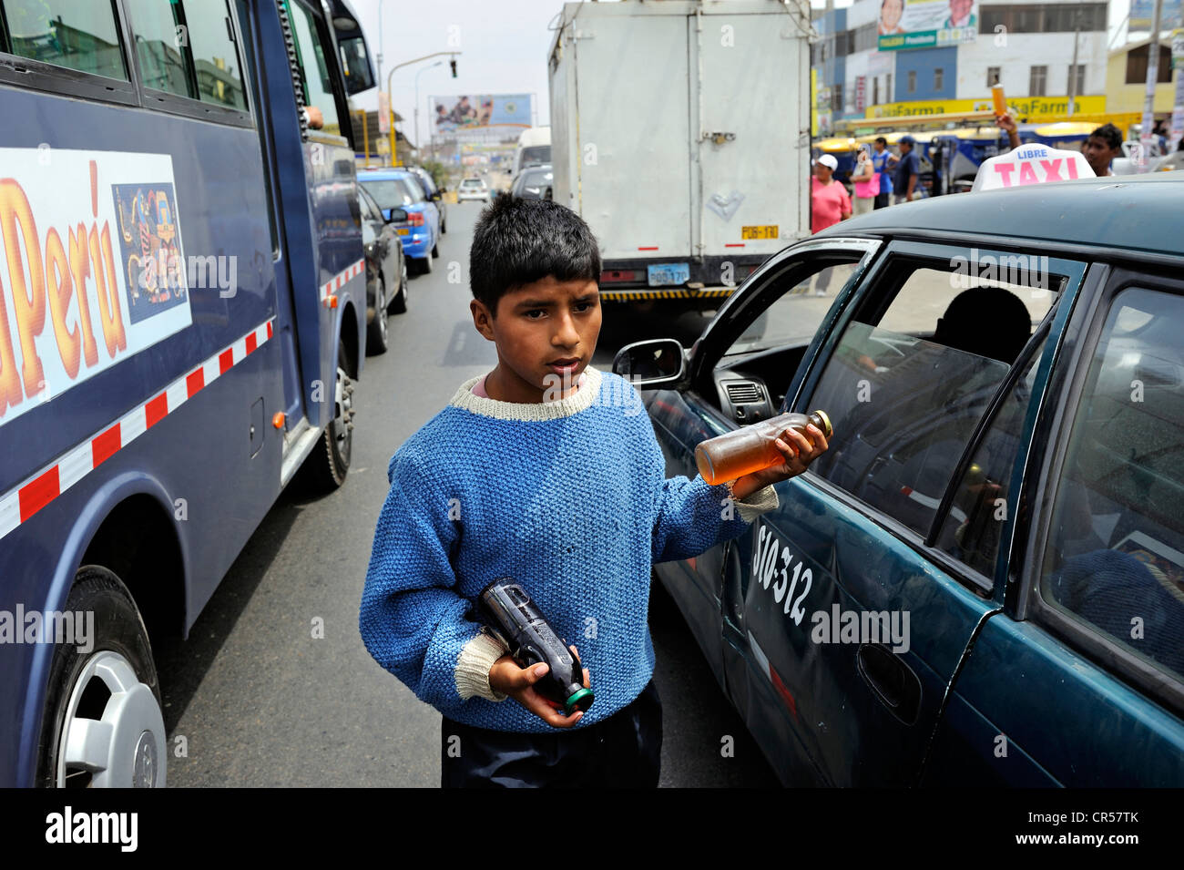 Child labour, boy, 11 years, selling soft drinks at an intersection ...