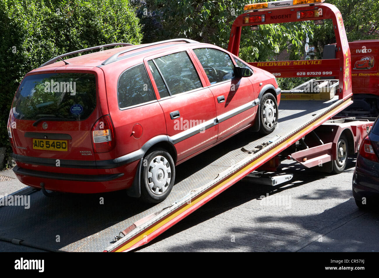 loading a broken down family car mpv onto a car transporter in the uk ...