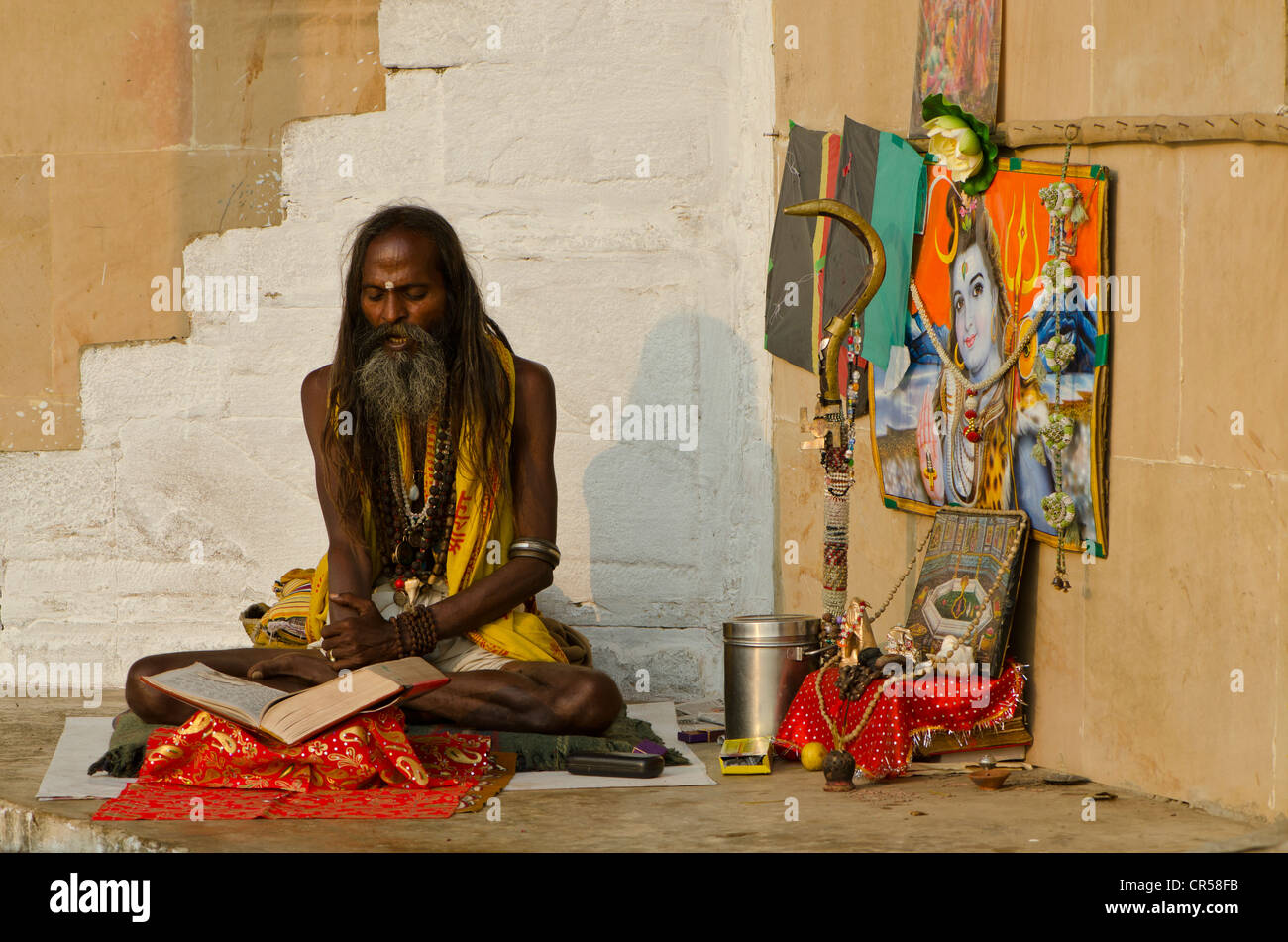 Chanting Sadhu reciting from the holy books at the ghats of Varanasi in ...