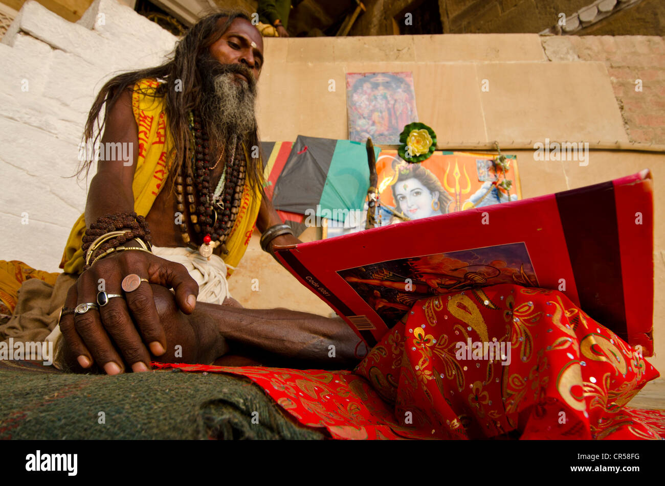 Chanting Sadhu reciting from the holy books at the ghats of Varanasi in ...