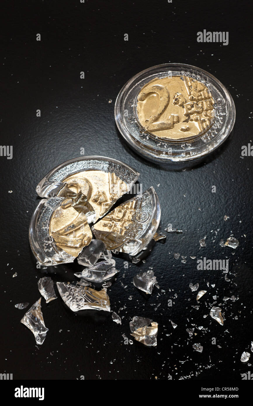 a smashed glass 2 euro coin next to an entire one Stock Photo - Alamy