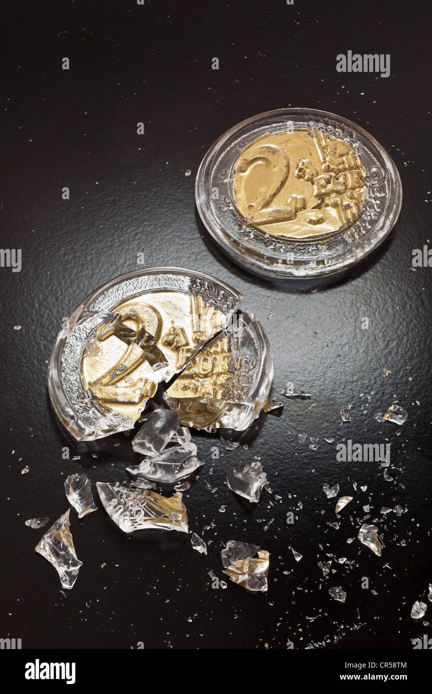 a smashed glass 2 euro coin next to an entire one Stock Photo - Alamy