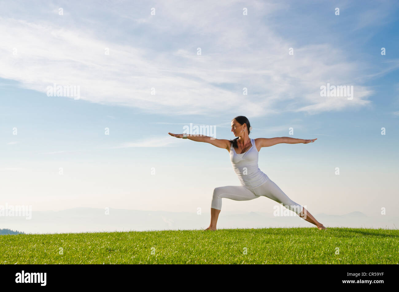 Young Woman Practising Hatha Yoga Outdoors Showing The Pose Virabhadrasana Ii Proud Warrior