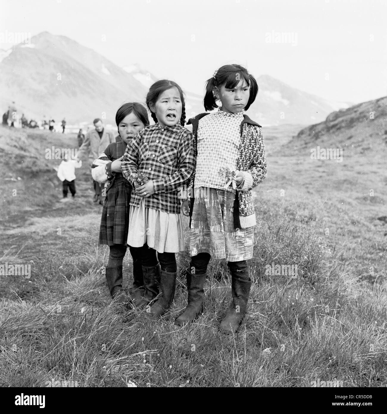 1950s. Historical image of three young Inuit or Eskimo girls standing ...
