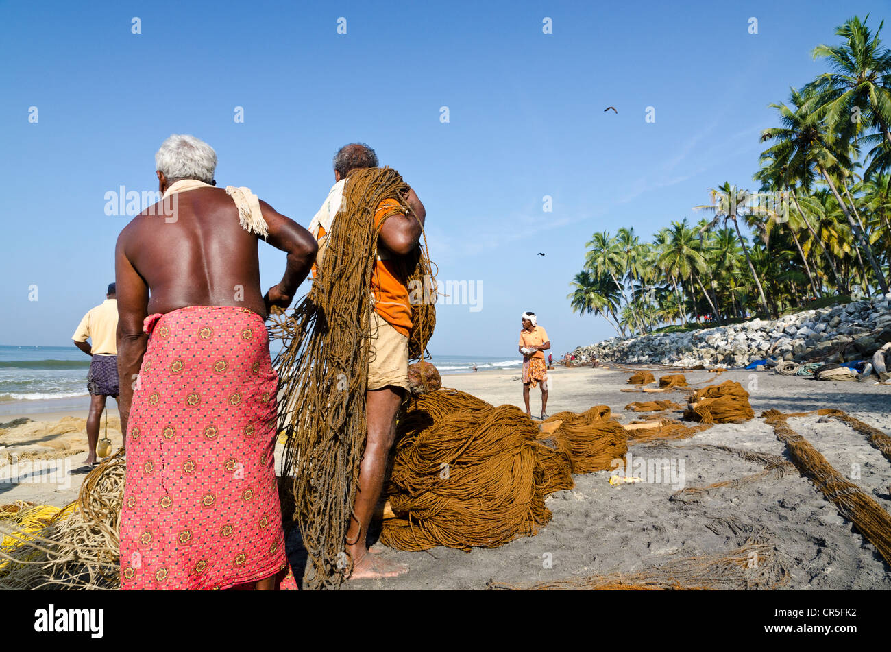 Fishermen fishing the traditional way, in a small village at the coast ...