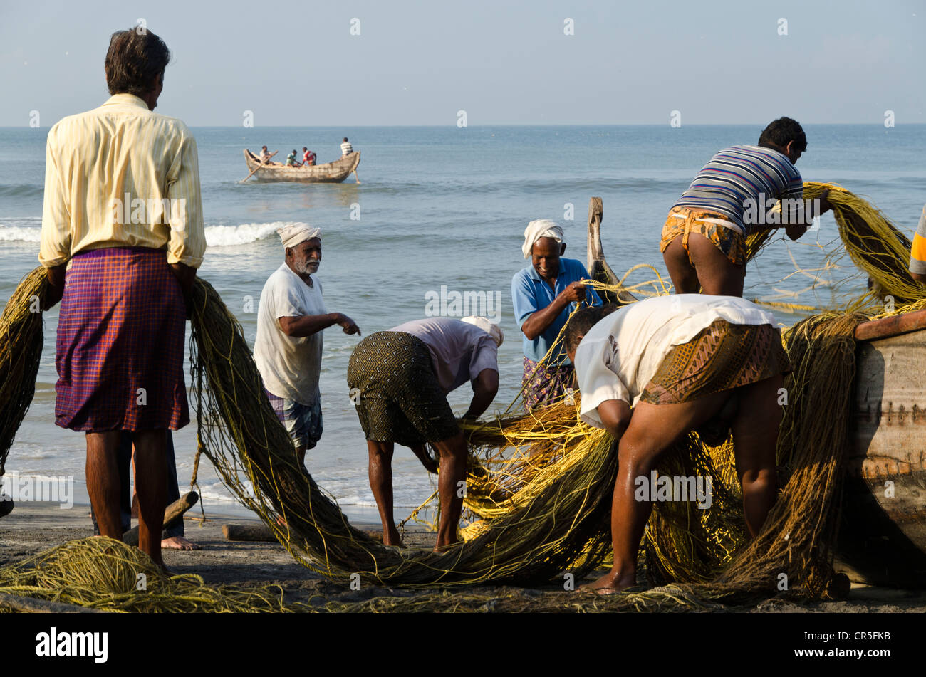 Fishermen fishing the traditional way, in a small village at the coast ...