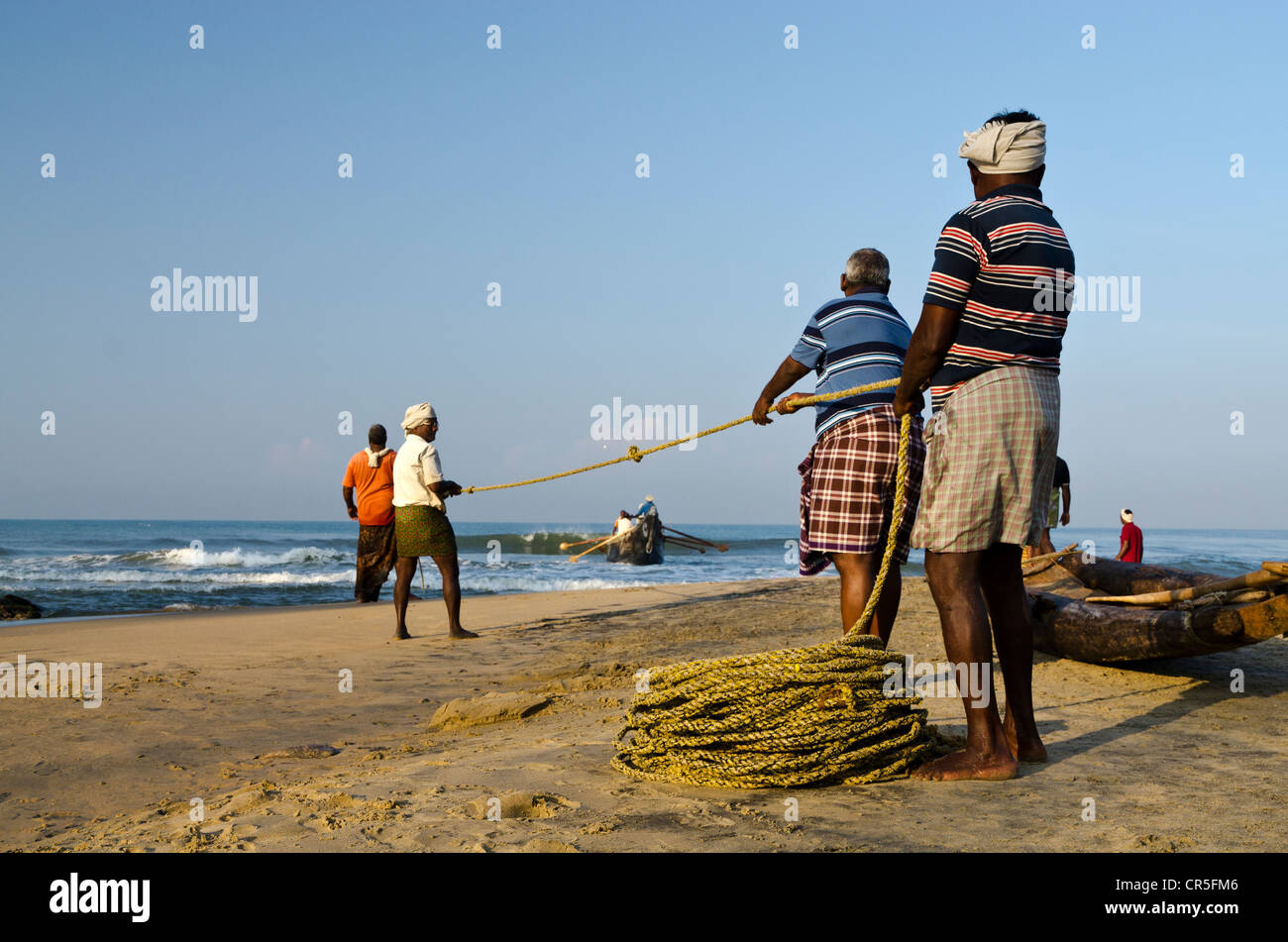 Fishermen fishing the traditional way, in a small village at the coast ...