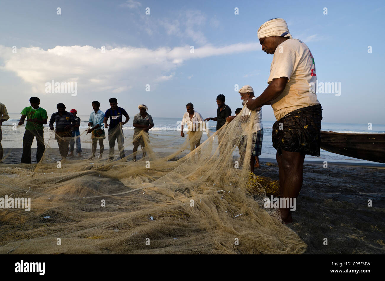 Fishermen fishing the traditional way, in a small village at the coast ...