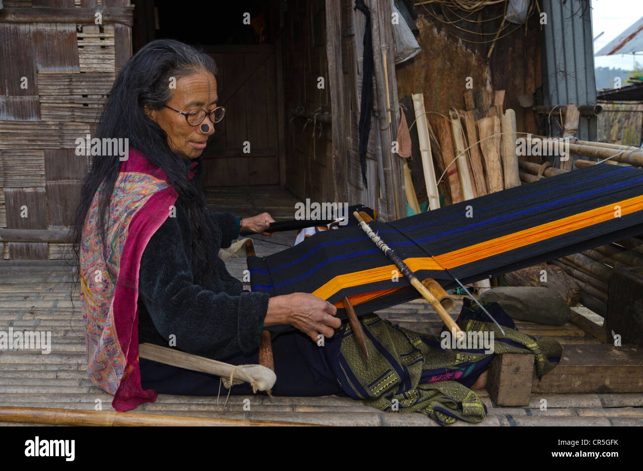 Apatani woman weaving material at a traditional hand loom, Hani ...