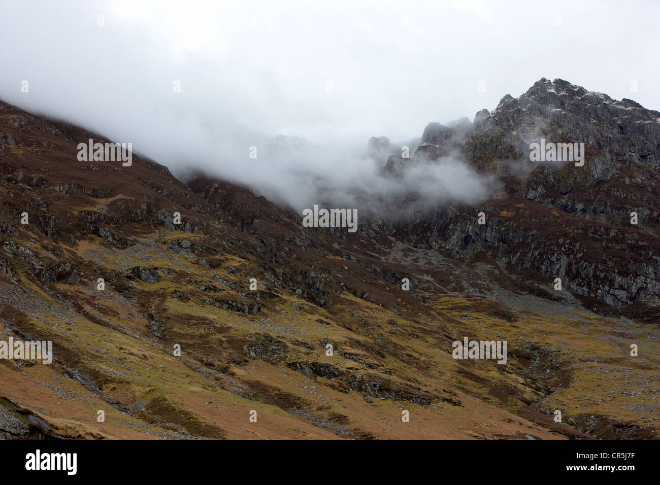 snow capped mountains covered in scotch mist in aonach eagach ridge ...
