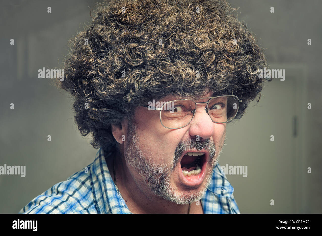 Angry man wearing a wig screaming with his mouth wide open Stock Photo ...