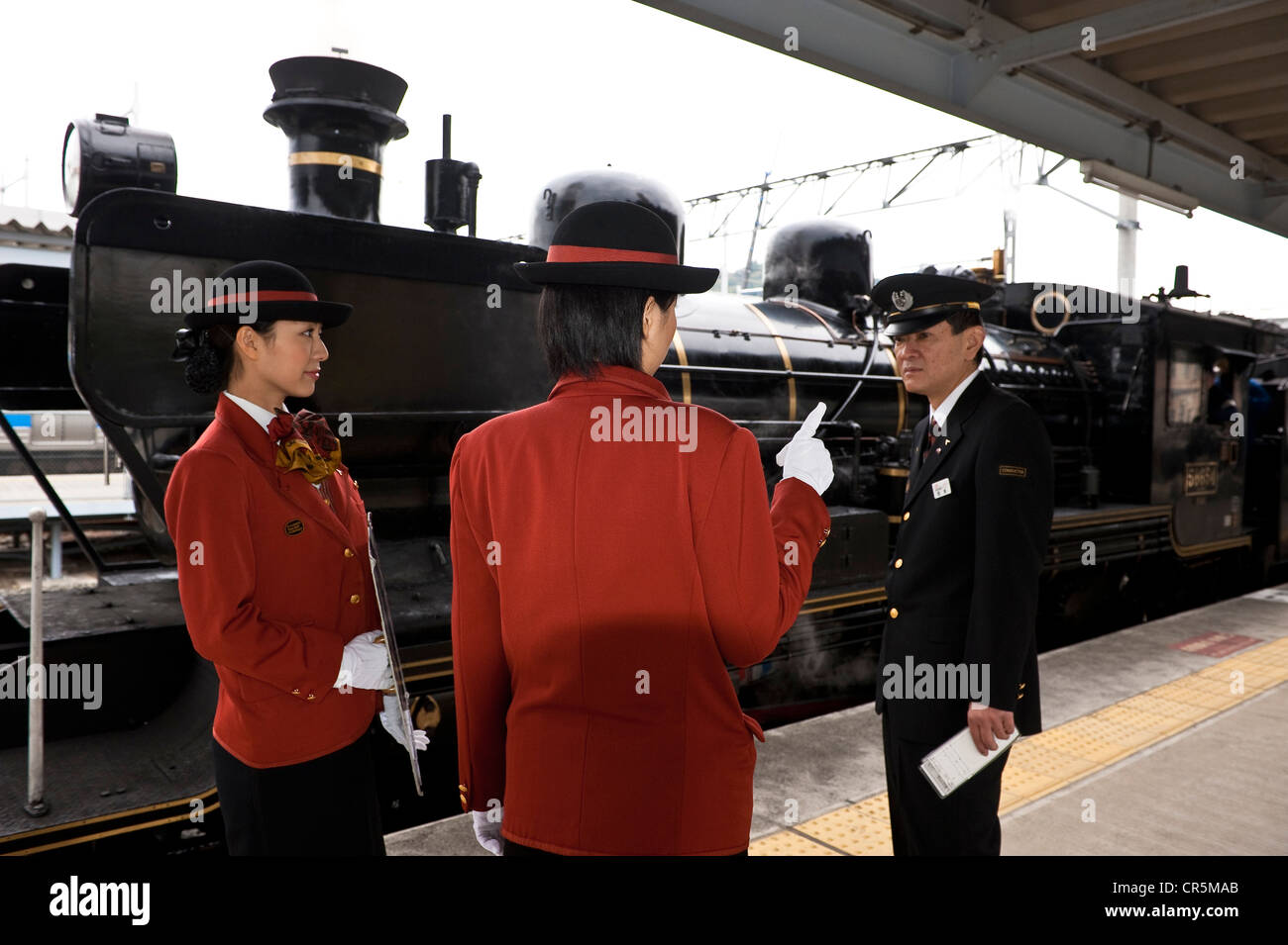 Japan, Kyushu Island, steam train at departure from the city of ...